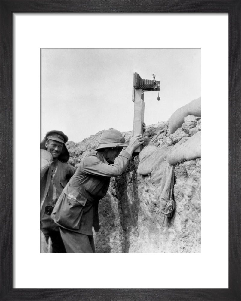 Soldier taking a photograph with a camera attached to a periscope, c 1 ...